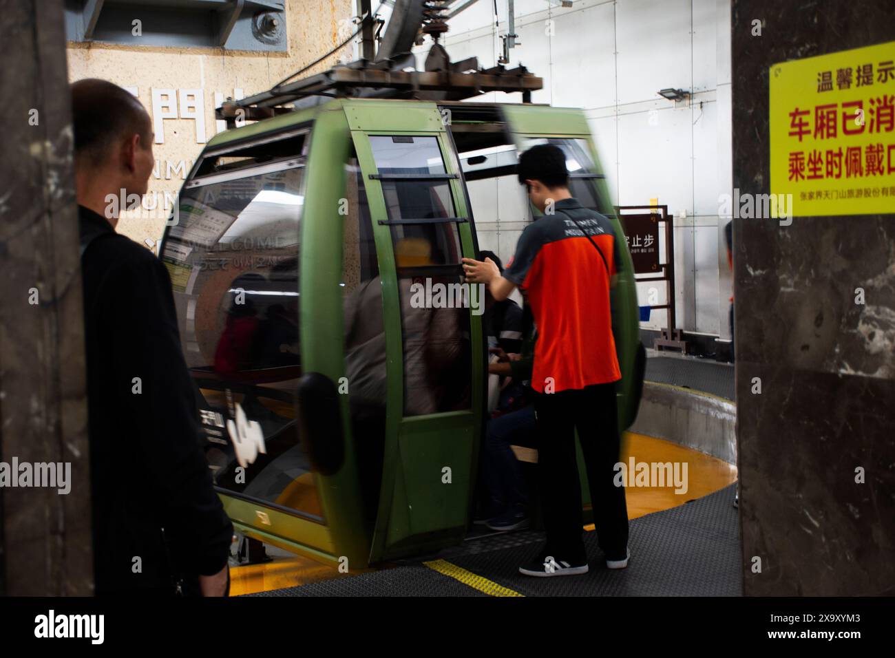 Chinese people and foreign travelers at station use cable cars cableway ...