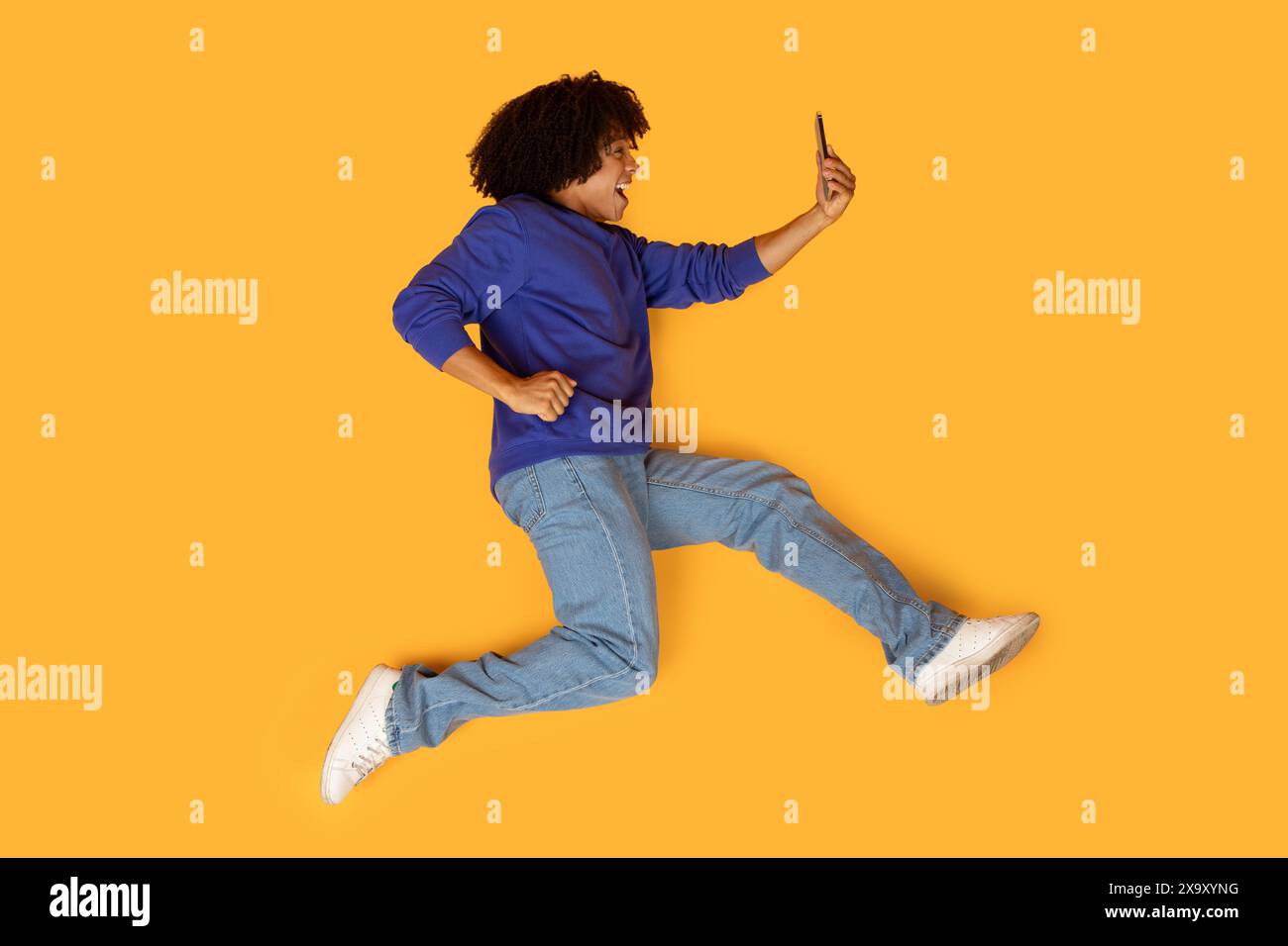 Man Jumping in the Air With Cell Phone Stock Photo - Alamy