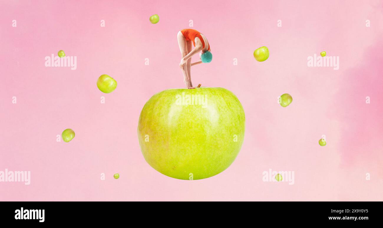 Young woman in red swimsuit and swimming cap standing on green apple ...
