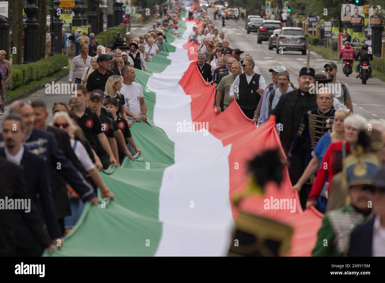 Budapest, Hungary. 2nd June, 2024. People march with a 1,848-meter-long Hungarian flag to ...