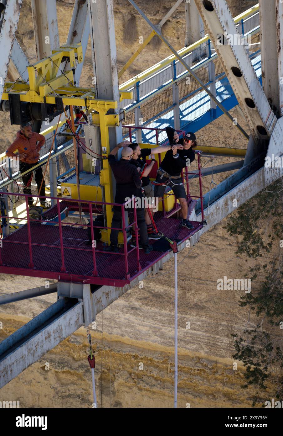 Bungee jumper having his picture taken before launching himself off the ...