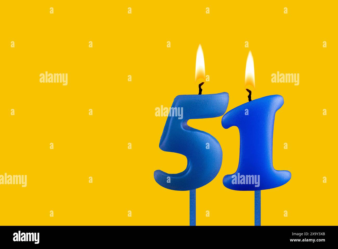 Blue birthday candle on yellow background - Number 51 Stock Photo - Alamy