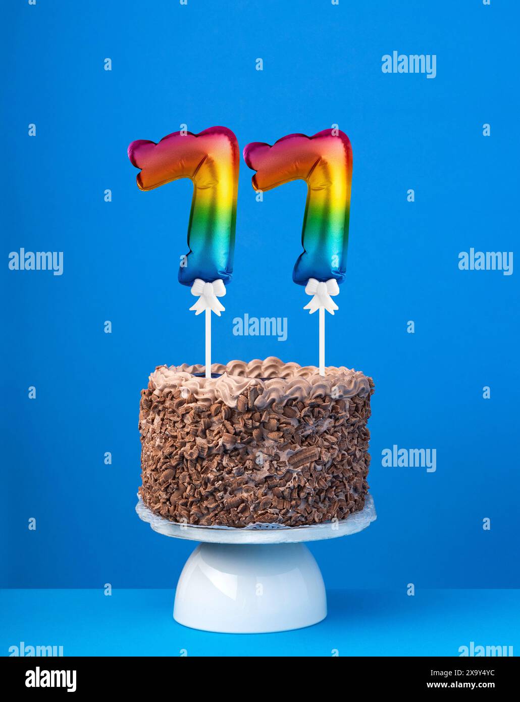 Air balloon number 77 - Birthday cake on blue background Stock Photo ...