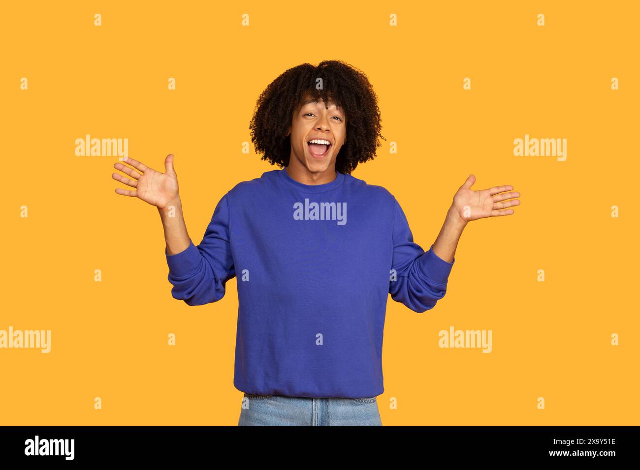 Happy Guy Expressing Joy Against Vibrant Yellow Background Stock Photo ...