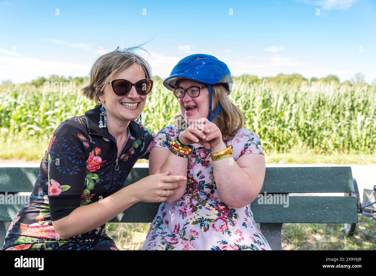 Down Syndrome woman connecting with her friends, both wearing a summer ...
