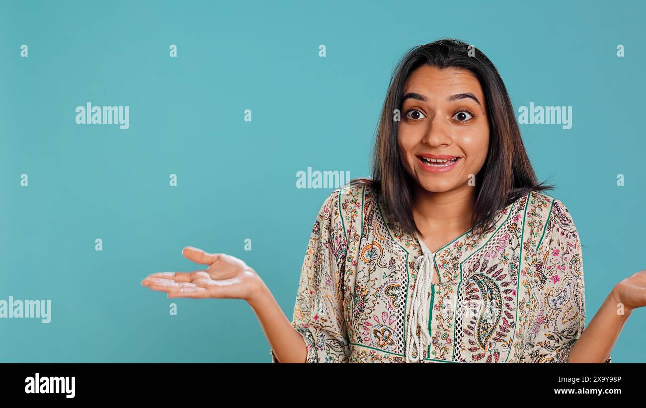 Indian woman shrugging shoulders, unable to provide answer, having ...
