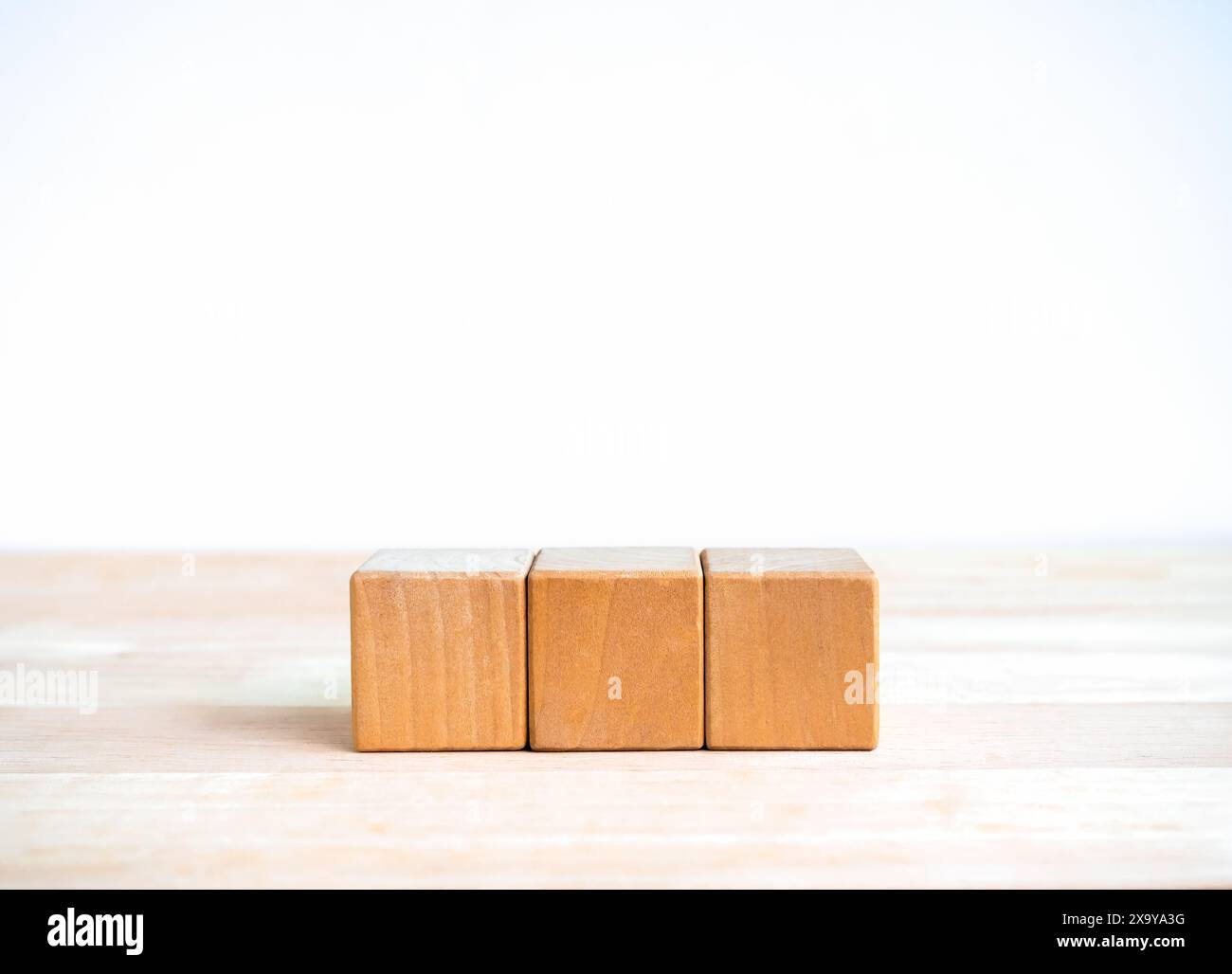 3 wood blocks isolated on wooden table, white banner background with ...