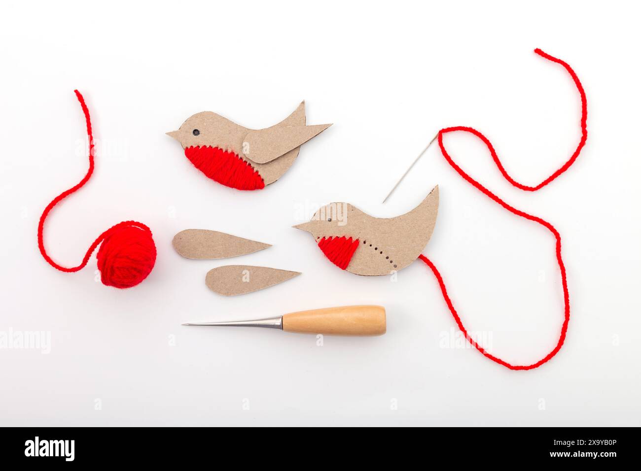 Bird-shaped cardboard craft with separate parts and assembly needle ...