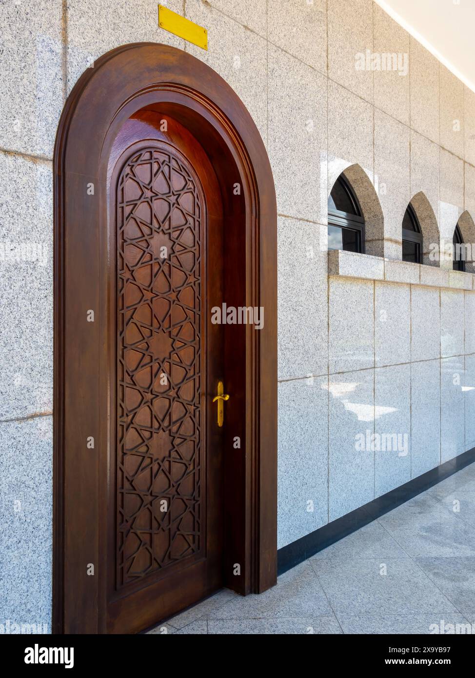 Beautiful pattern on curved wooden door with gold handle, decoration of ...
