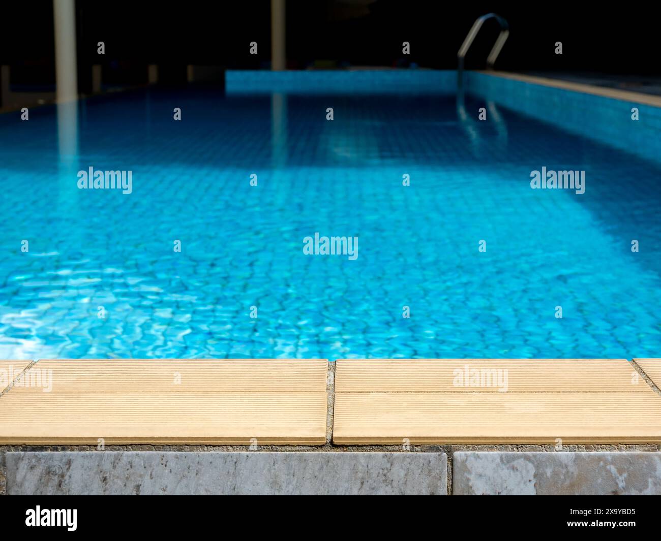 Summer pool background. Empty space on the pool edge, stone tiles and ...