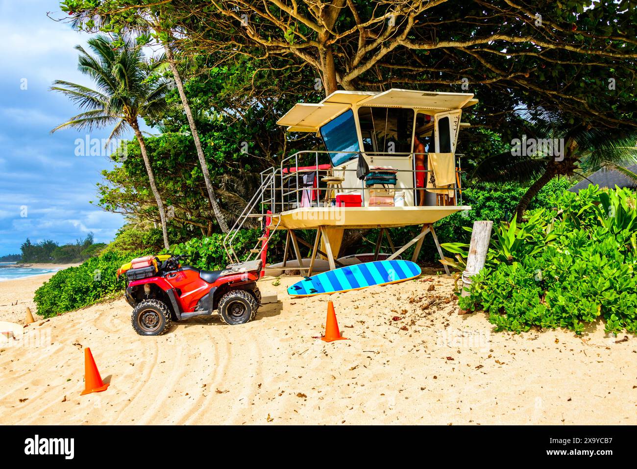 A small lifeguard station on the beach with orange cones and equipment ...