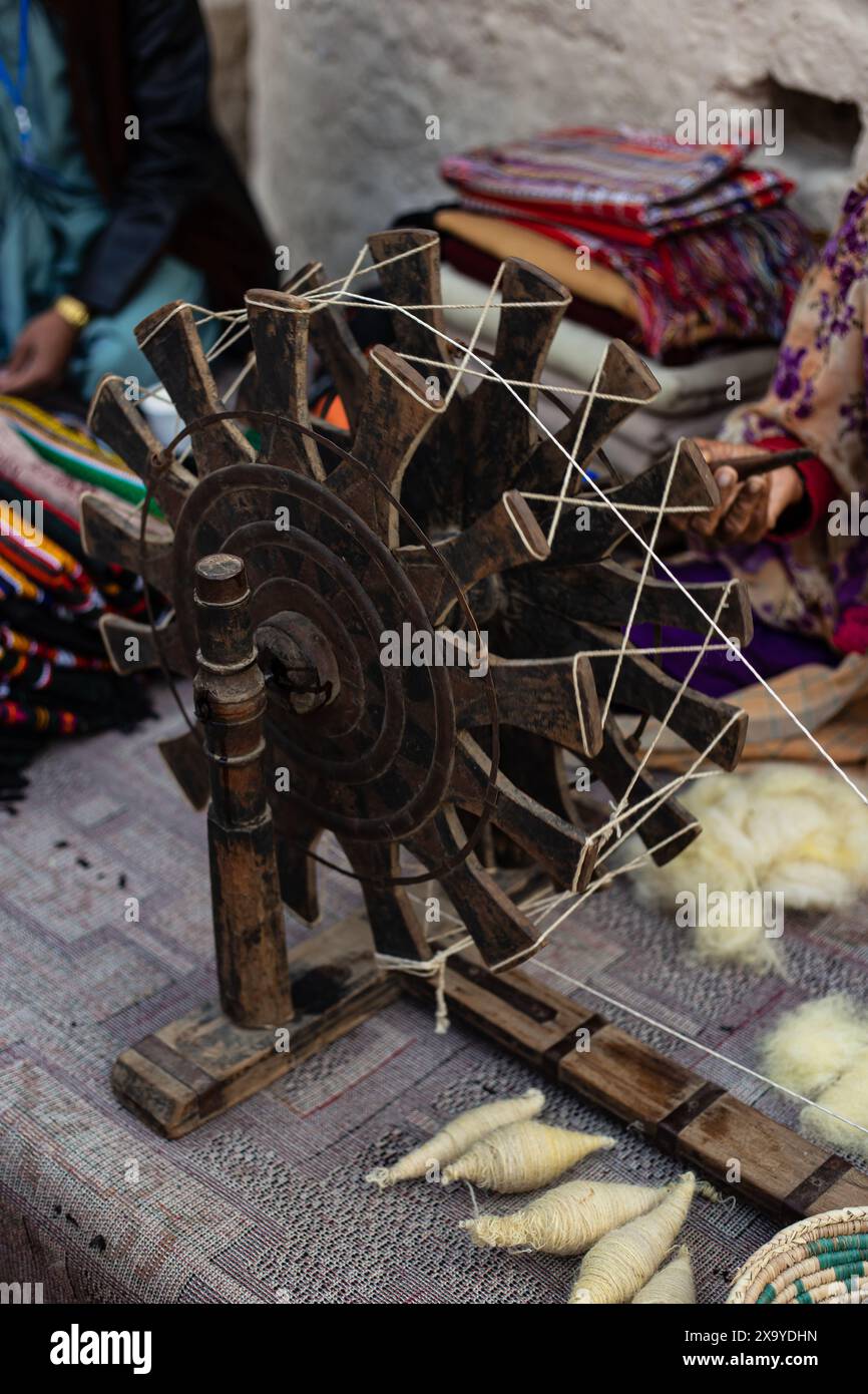 A demonstration of a traditional cloth weaving machine at Lok Mela ...