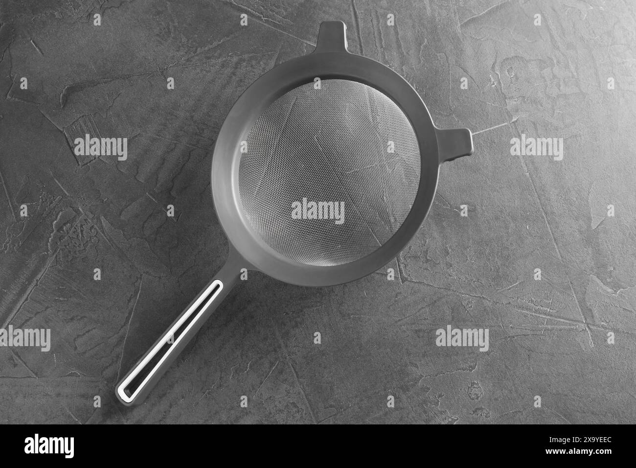 One new sieve on grey table, top view Stock Photo - Alamy