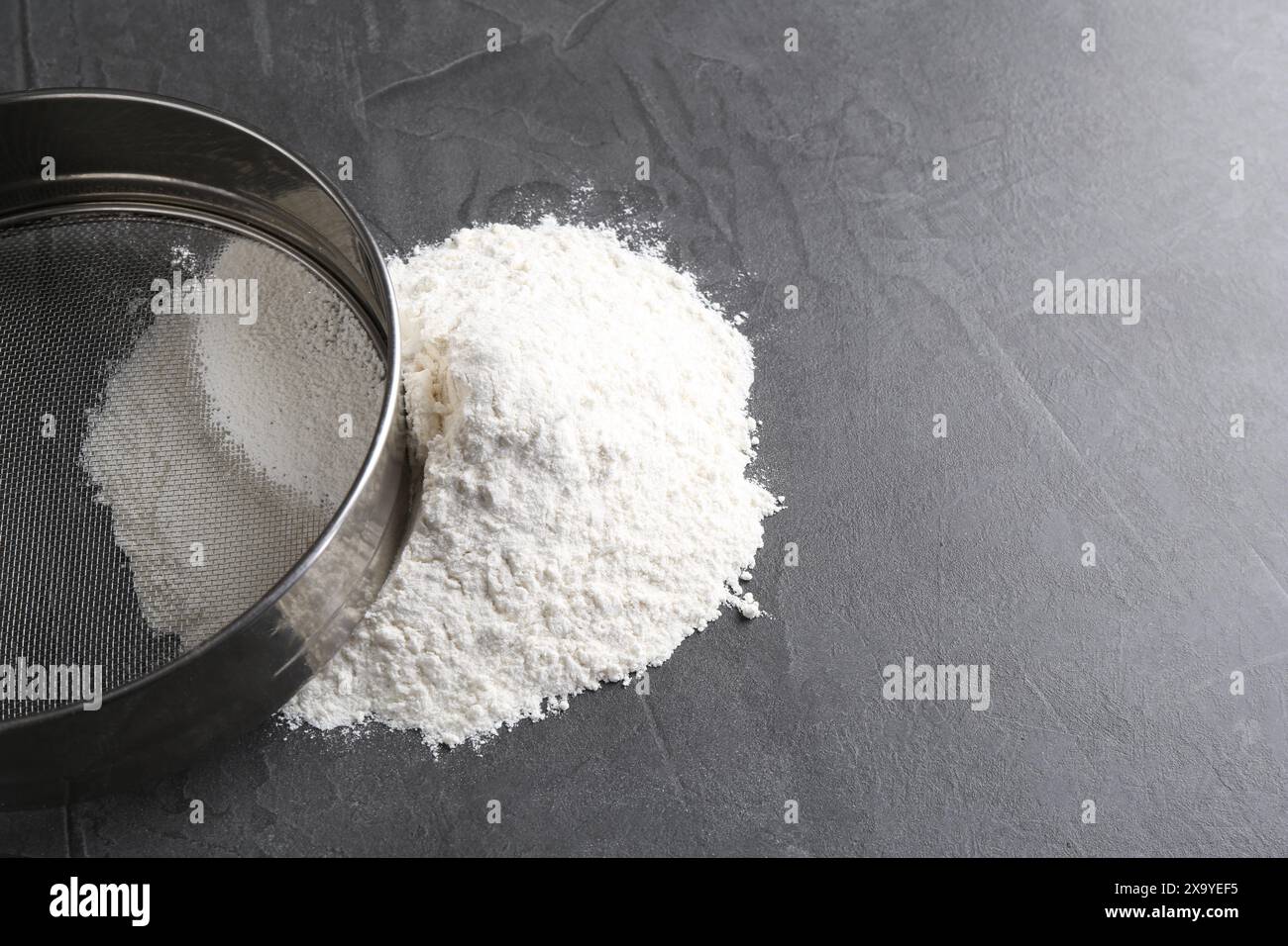 Metal sieve and flour on grey table. Space for text Stock Photo - Alamy