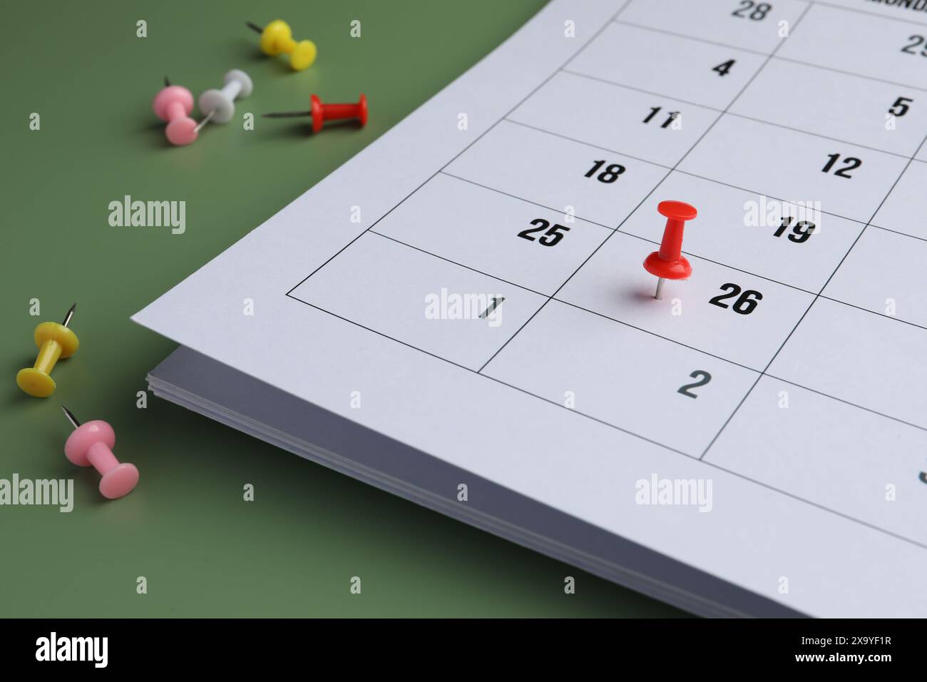 Timetable. Calendar and drawing pins on green background, closeup Stock ...