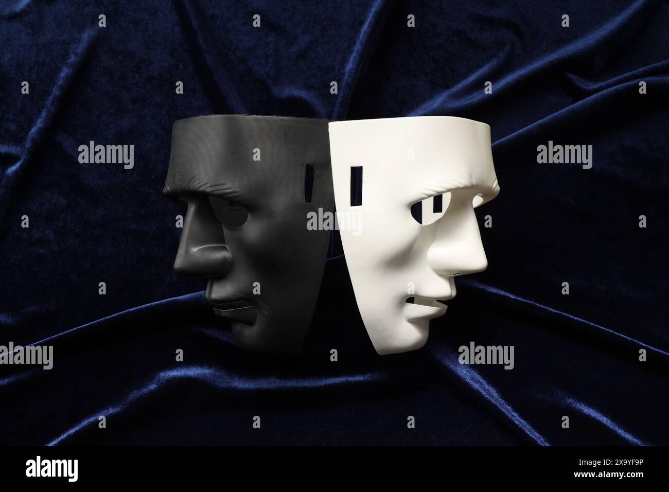 Theater arts. Two masks on blue fabric, top view Stock Photo - Alamy