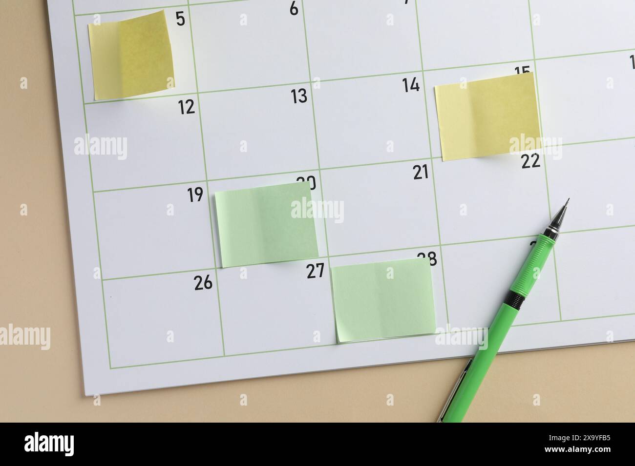 Timetable. Calendar page with sticky notes and pen on beige background ...