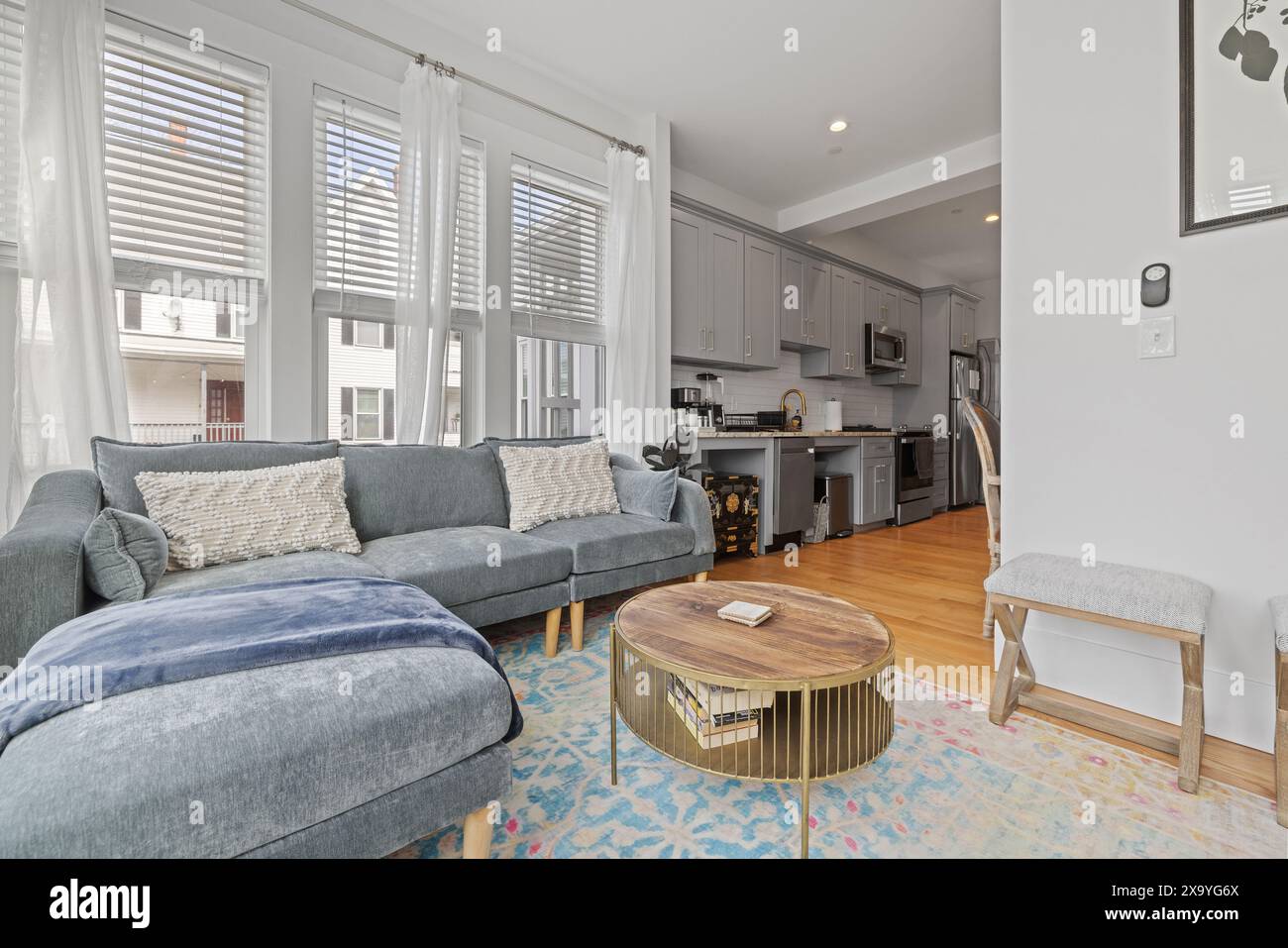 A well-furnished living room with multiple chairs and a sofa Stock ...