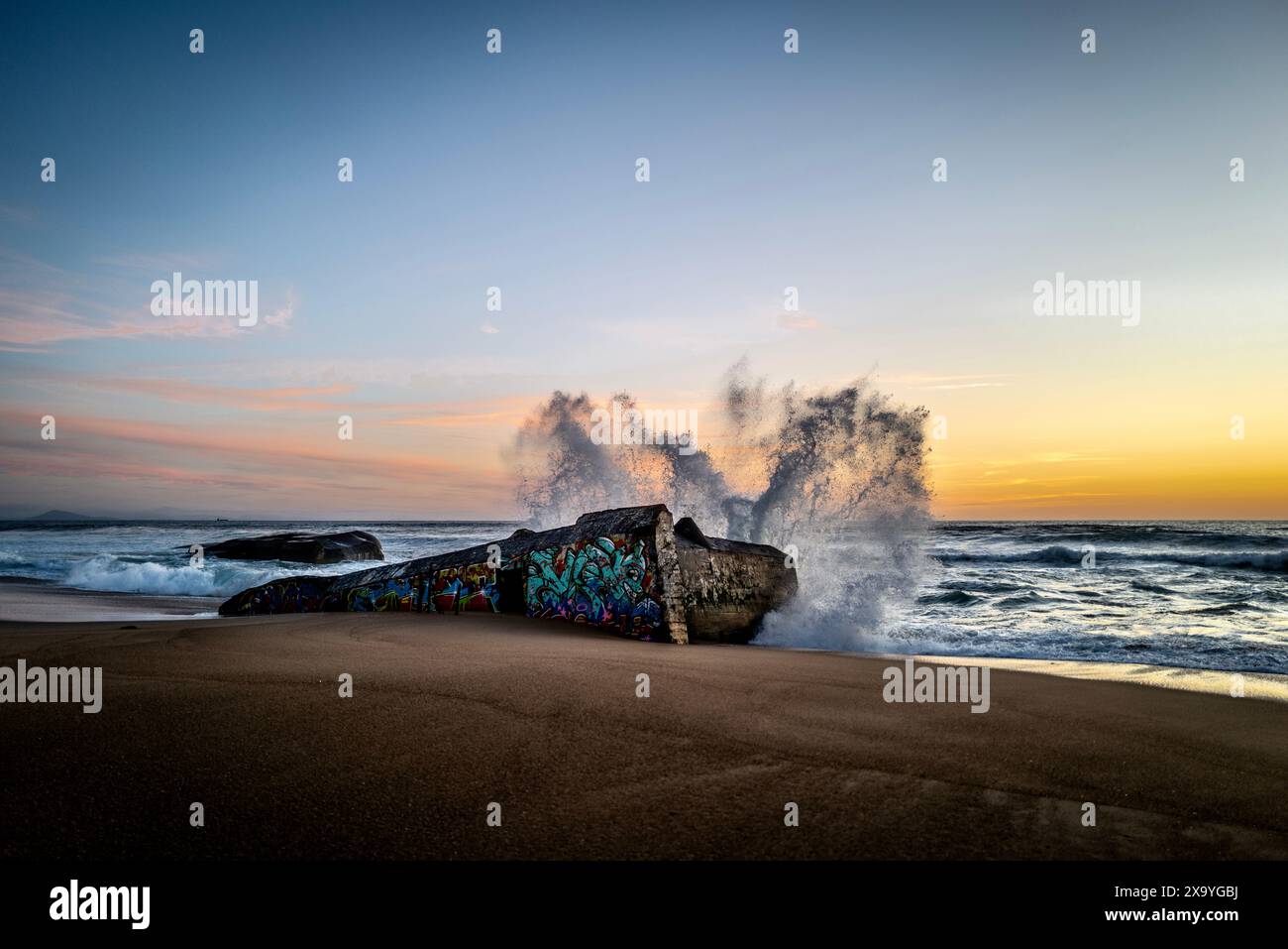 Military bunker from World War II with sunset and fountain of a wave on ...