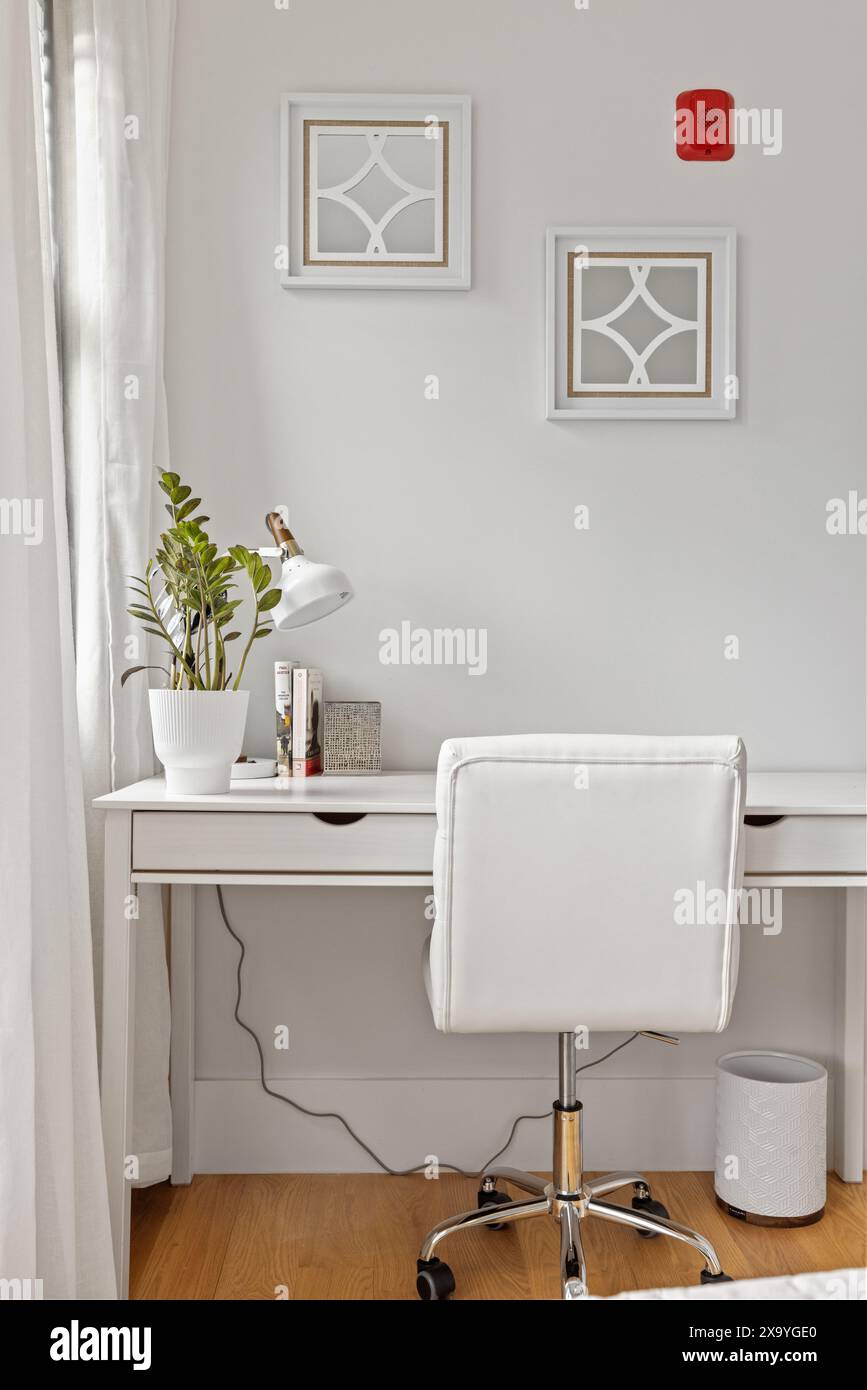 White desk in a bright white bedroom with wooden floors Stock Photo - Alamy