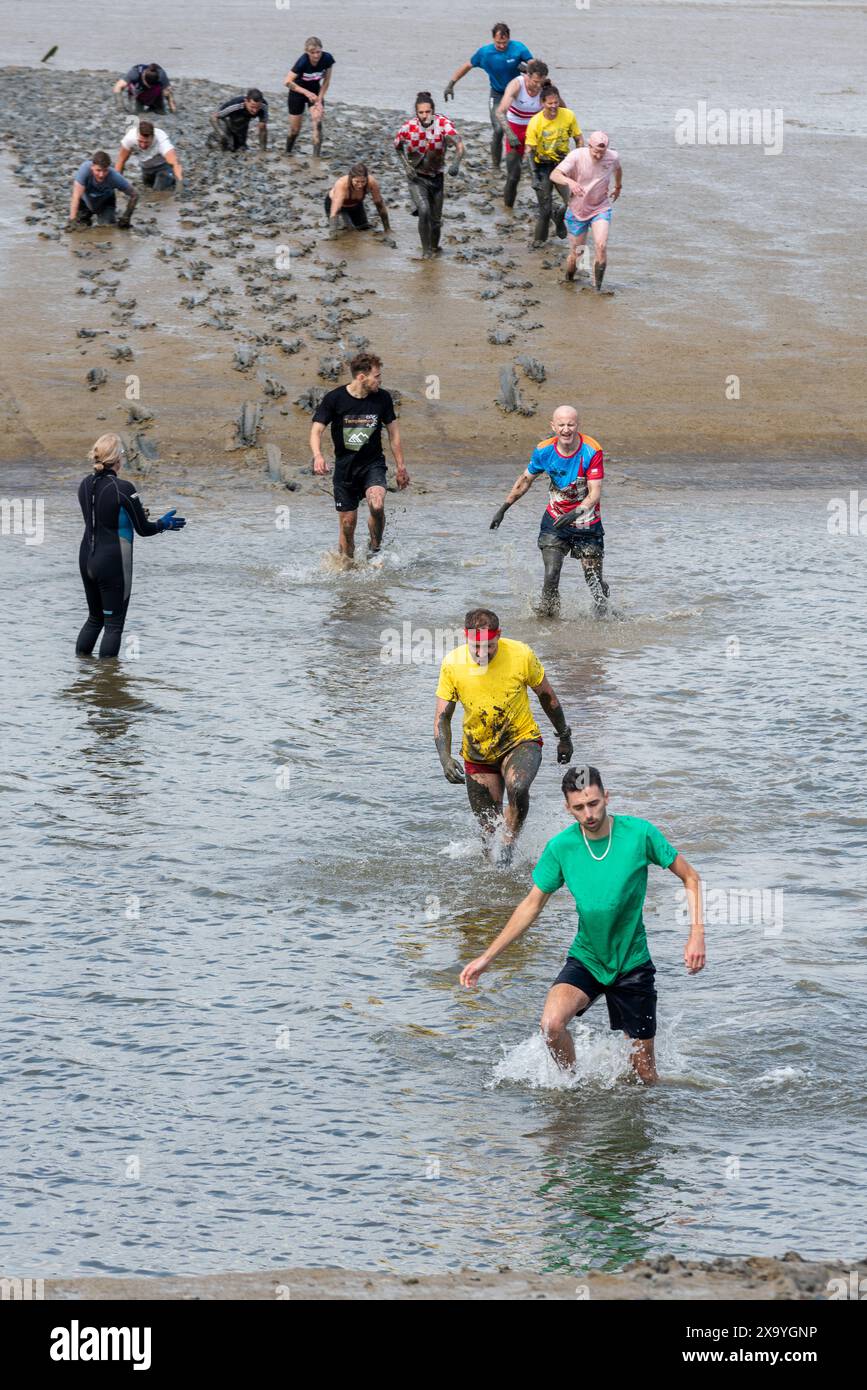 Leading runners in the Maldon Mud Race 2024 in Maldon, Essex, UK, in ...