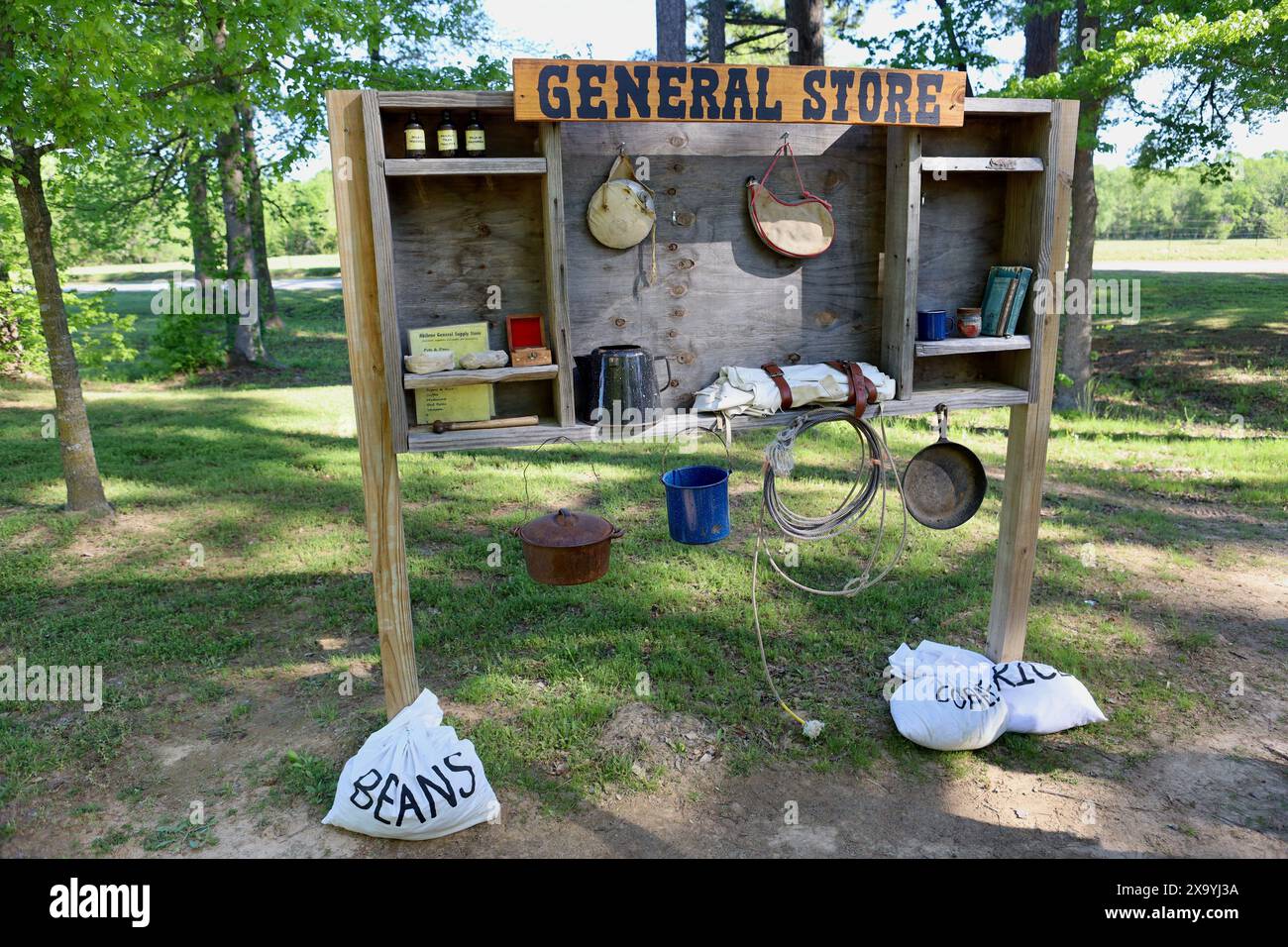 Two hanging buckets in a rustic wood shop filled with cooking pots and ...