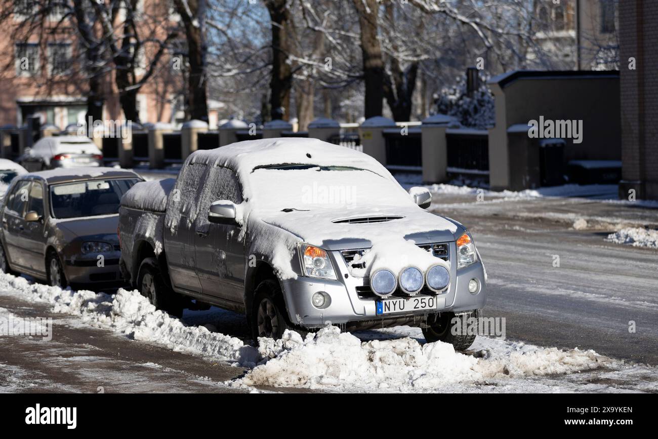 snow-covered cars on the road near the shopping center Stock Photo - Alamy