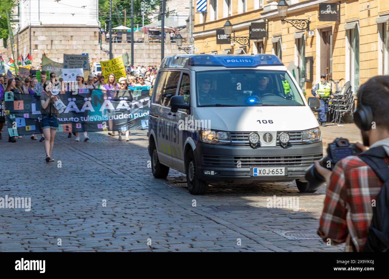 Police escorting the Lisää ääntä climate protest along Unioninkatu in ...