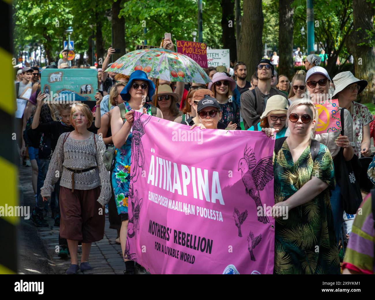Participants carrying a "Mothers's rebellion" banner in the Lisää ääntä ...