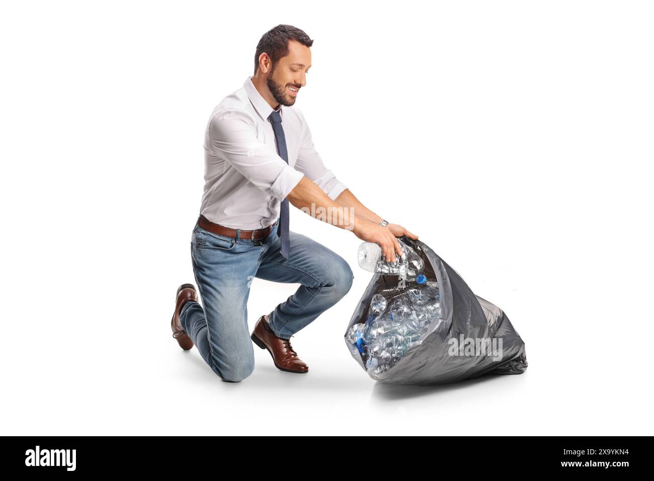 Businessman collecting bottles and putting them in a plastic bag ...