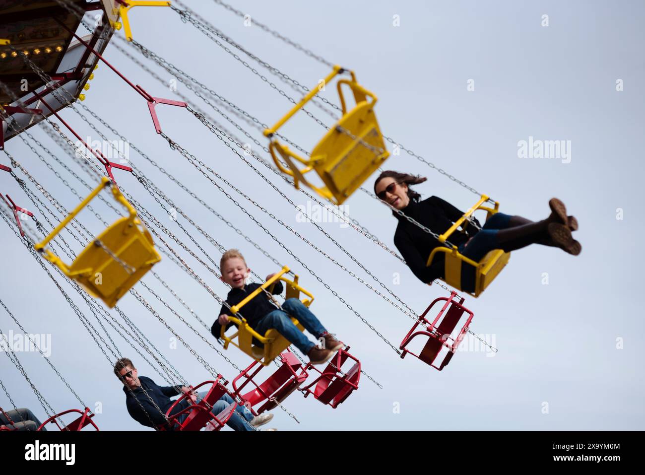 People on the Chair-o-planes at the funfair at the 81st Members ...