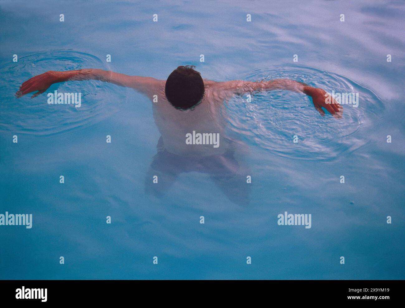 Man floating on the water in a swimming pool Stock Photo - Alamy