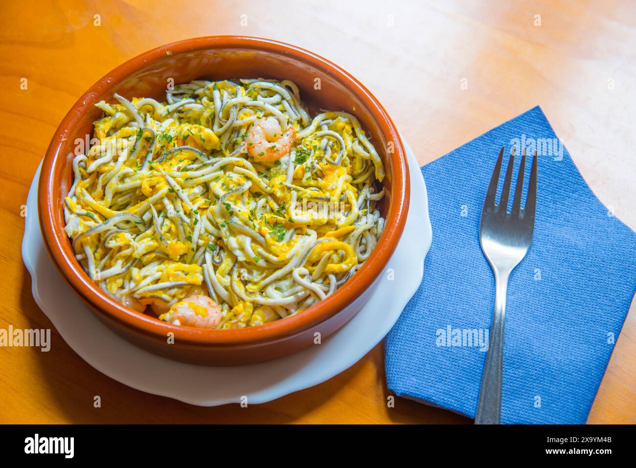 Spanish tapa: eels with eggs, prawns and parsley Stock Photo - Alamy