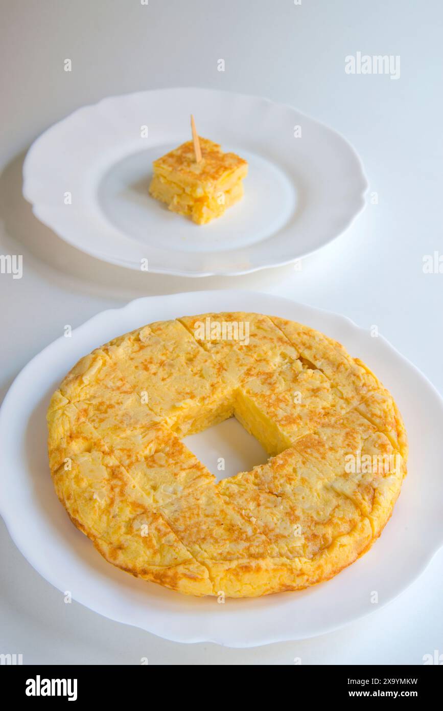 Spanish omelet cut into pieces in a dish, and a piece of it in another ...