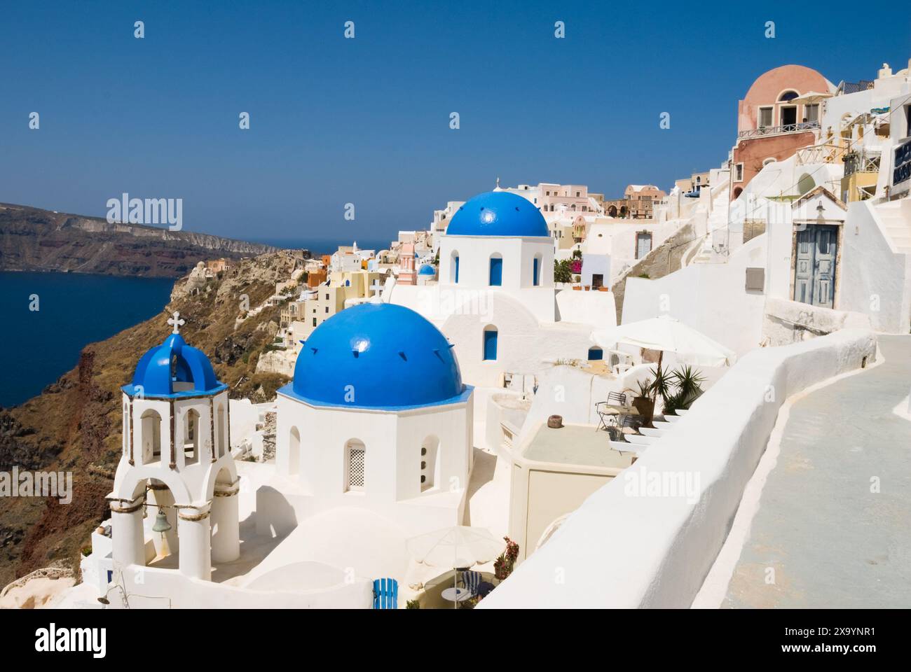 A scenic view of white and blue buildings in Oia, Greece Stock Photo ...