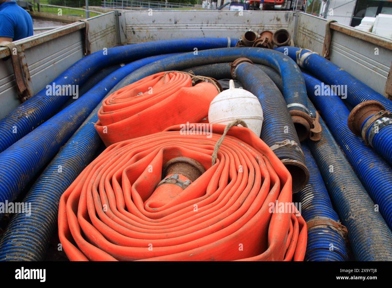 Hoses lie loosely on a trailer for transport Stock Photo - Alamy