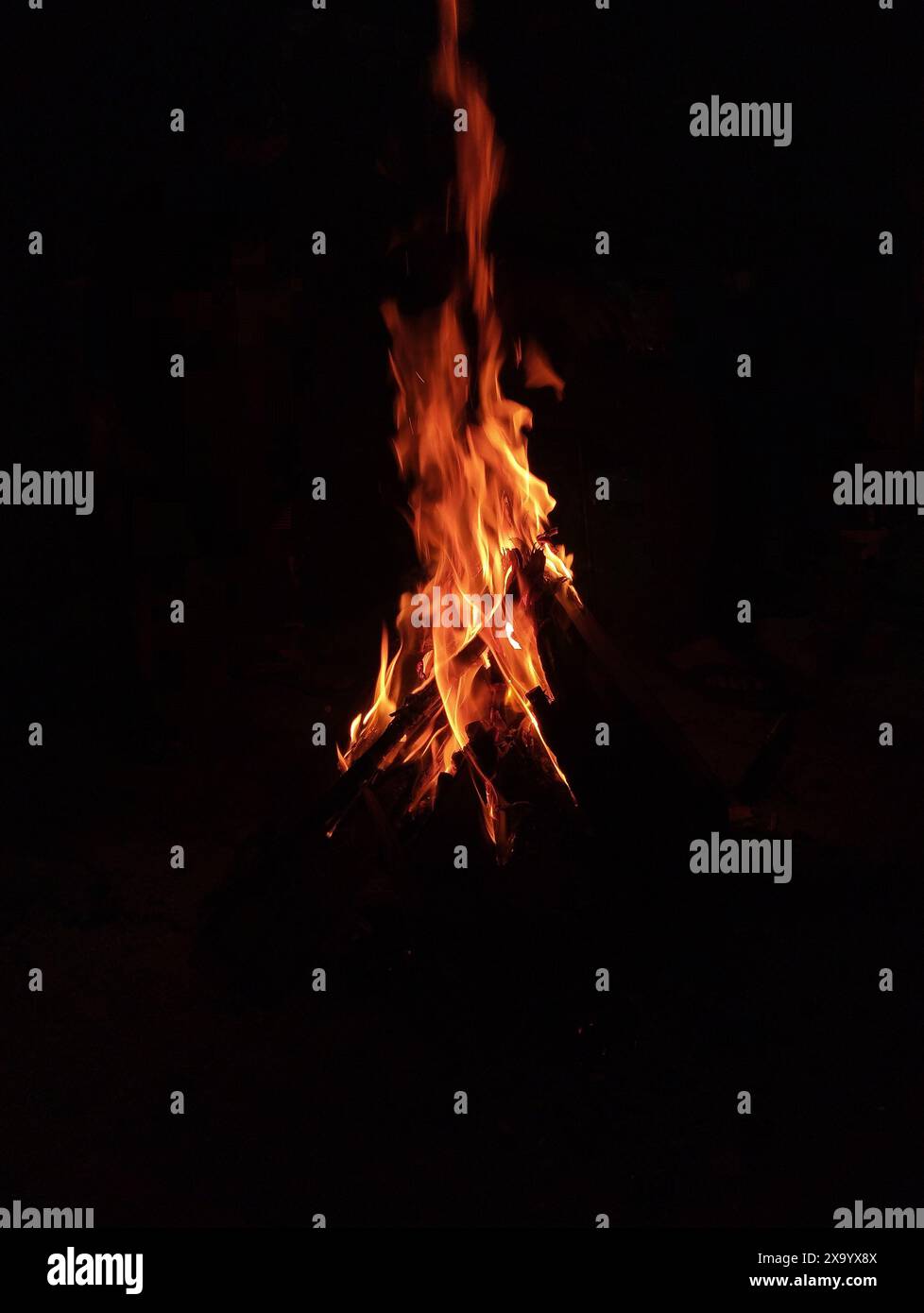 A bright bonfire glowing in the darkness Stock Photo - Alamy