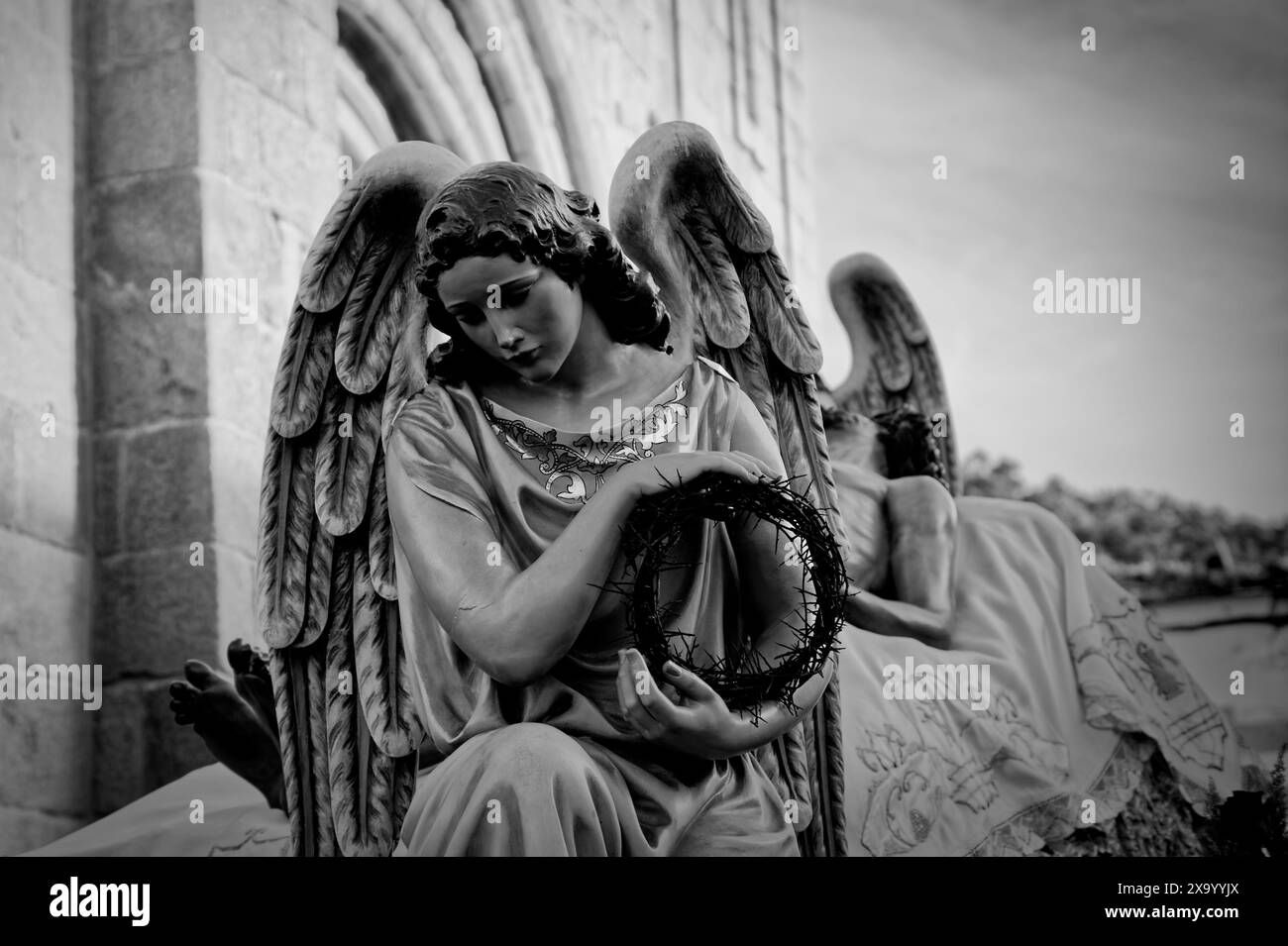 A statue of an angel carrying in his hands the crown of thorns of Jesus ...