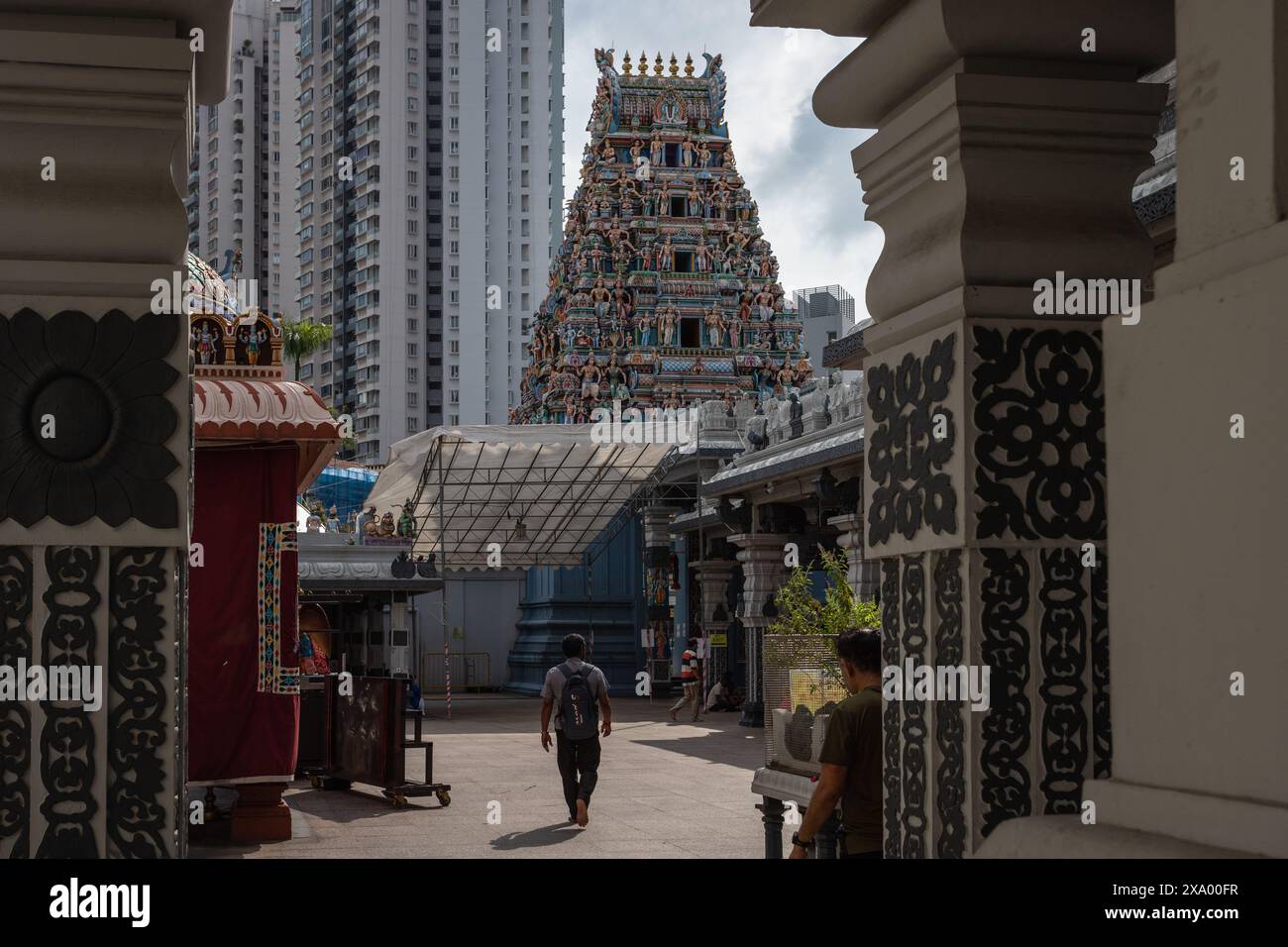 Man entering through the gate to a large entranceway: The Sri Srinivasa ...