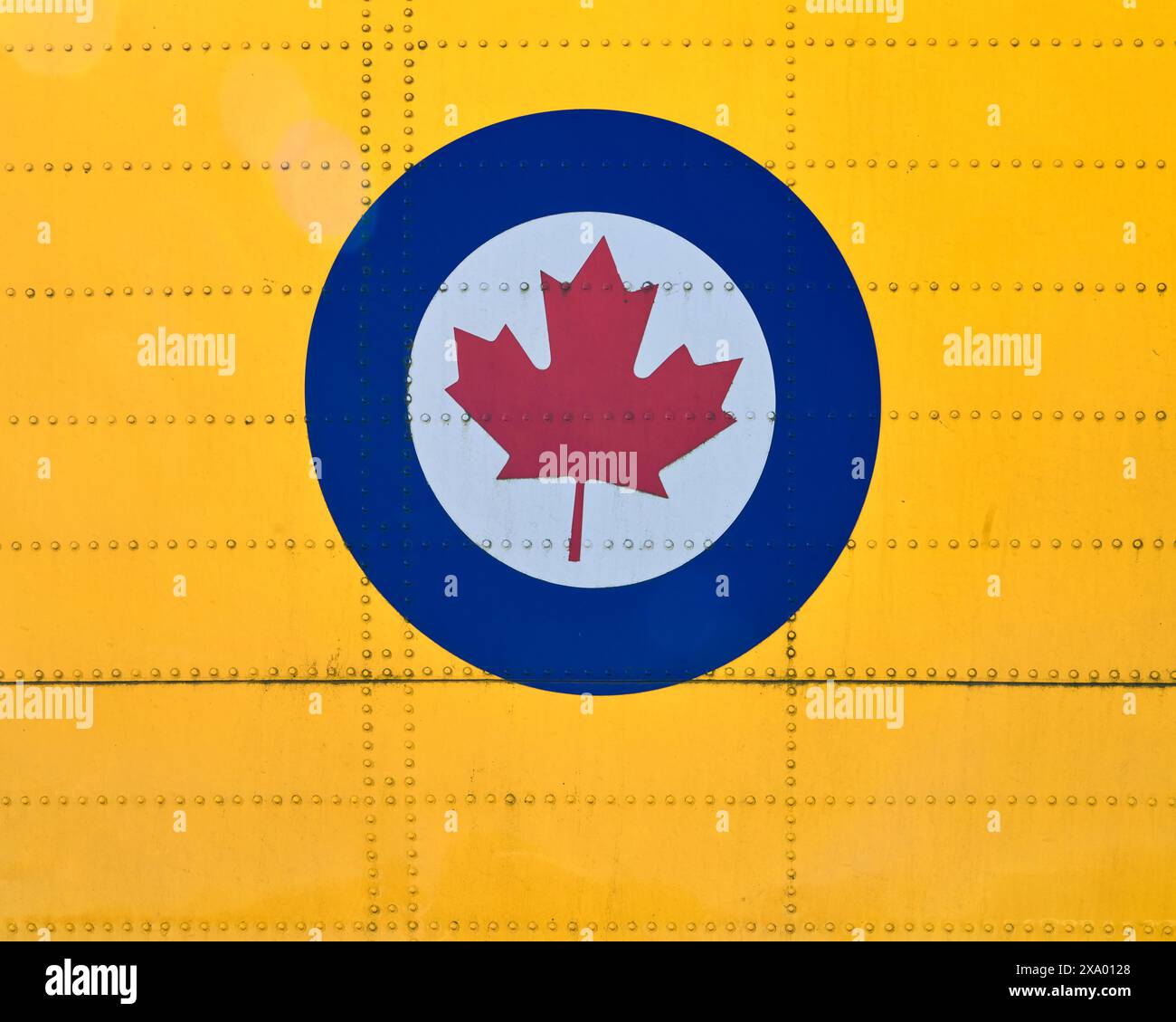 Close-up of the stylized red maple leaf in a white circle bordered by ...