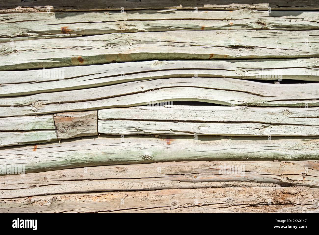 Timbers/logs in layers, making up the side of a building at the ...