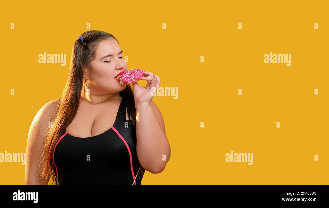 Tasty donut. Food pleasure. Sweet addiction. Chubby overweight model ...