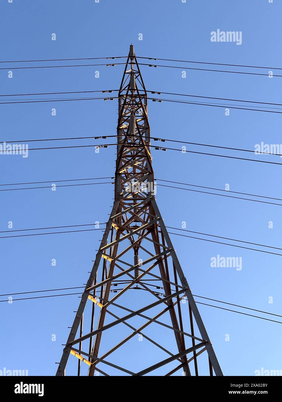 A utility tower standing tall under a clear blue sky Stock Photo - Alamy