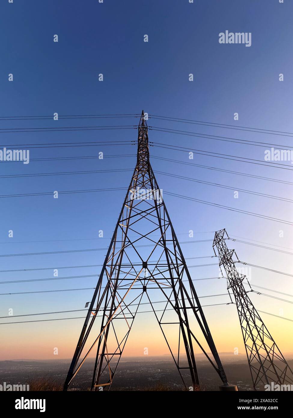 The utility towers standing tall under a clear blue sky Stock Photo - Alamy