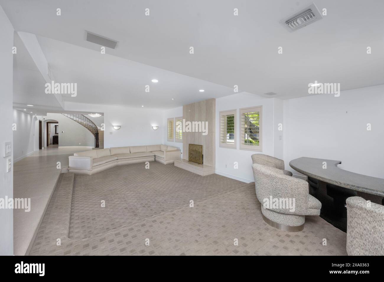 A room with numerous chairs and a couch in Encino, California Stock ...