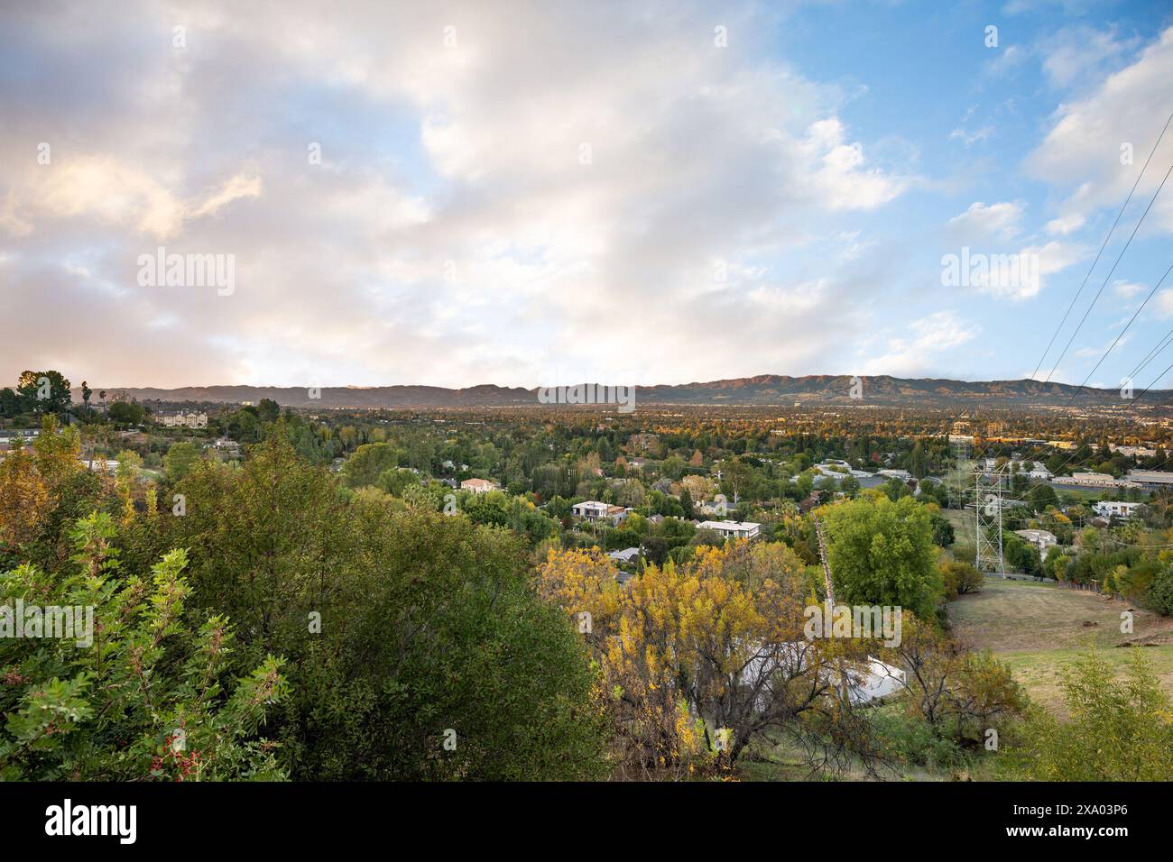An serial view of countryside homes under a picturesque cloudy sky in ...