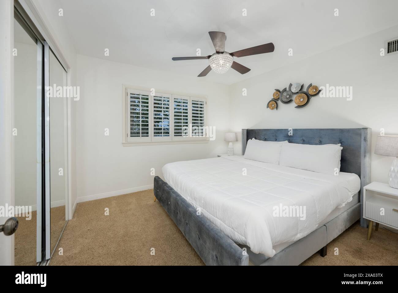 A bedroom with two beds and blinds in Hidden Hills Stock Photo - Alamy