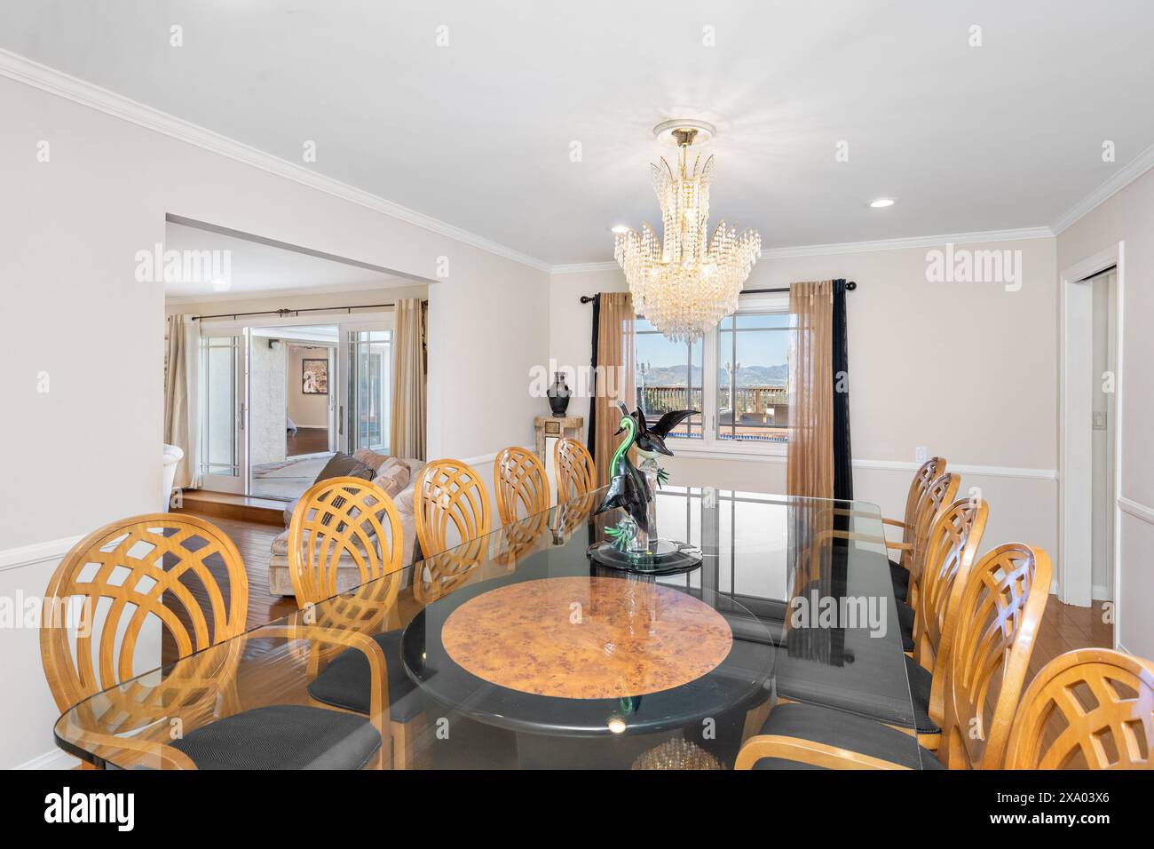 An elegant dining room with tall ceilings and a lengthy table in Encino ...