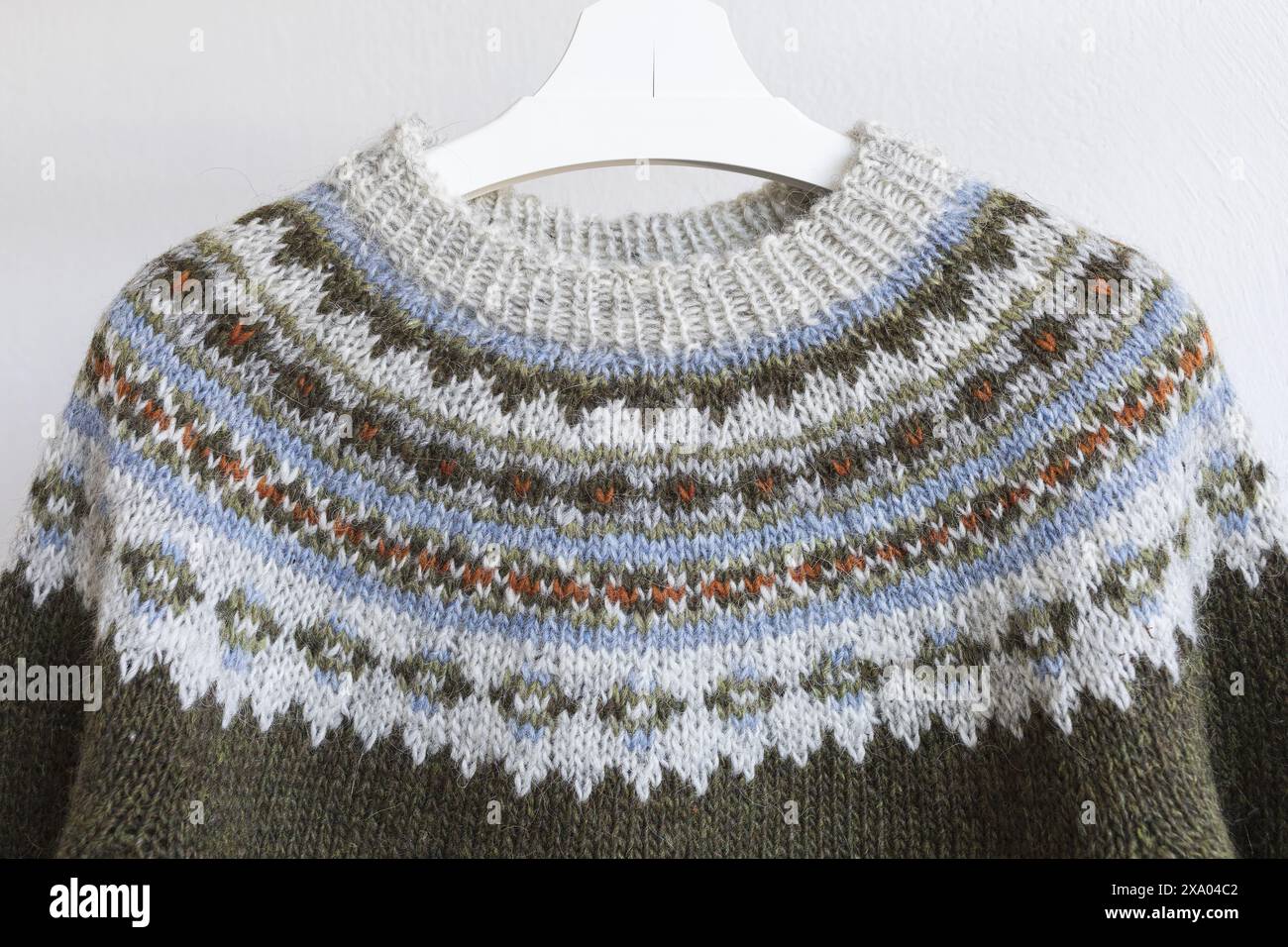 Close-up photo of an Icelandic wool knitted lopapeysa sweater with large colorful yoke in ...