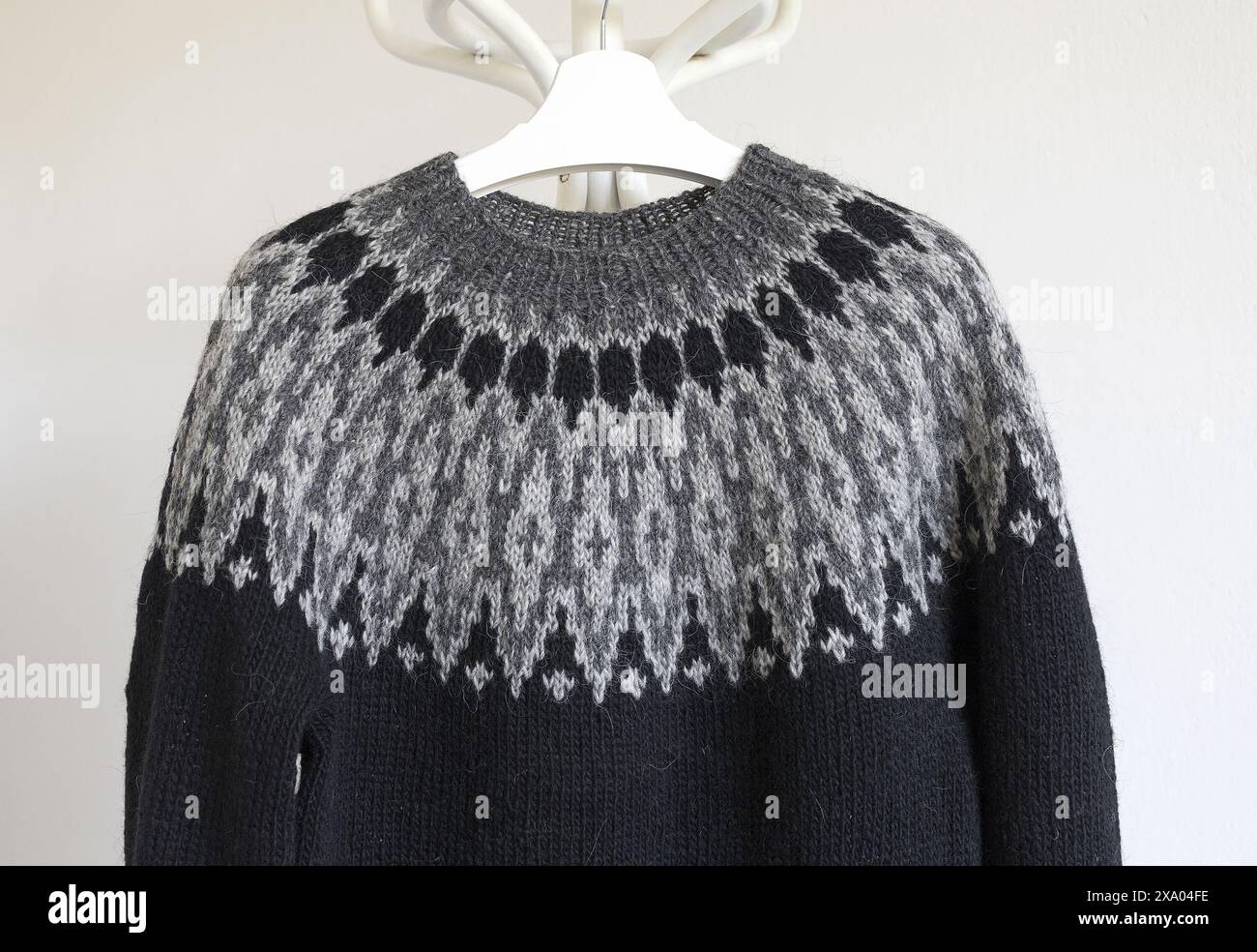 Close-up photo of a large grey and black yoke of a knitted wool ...